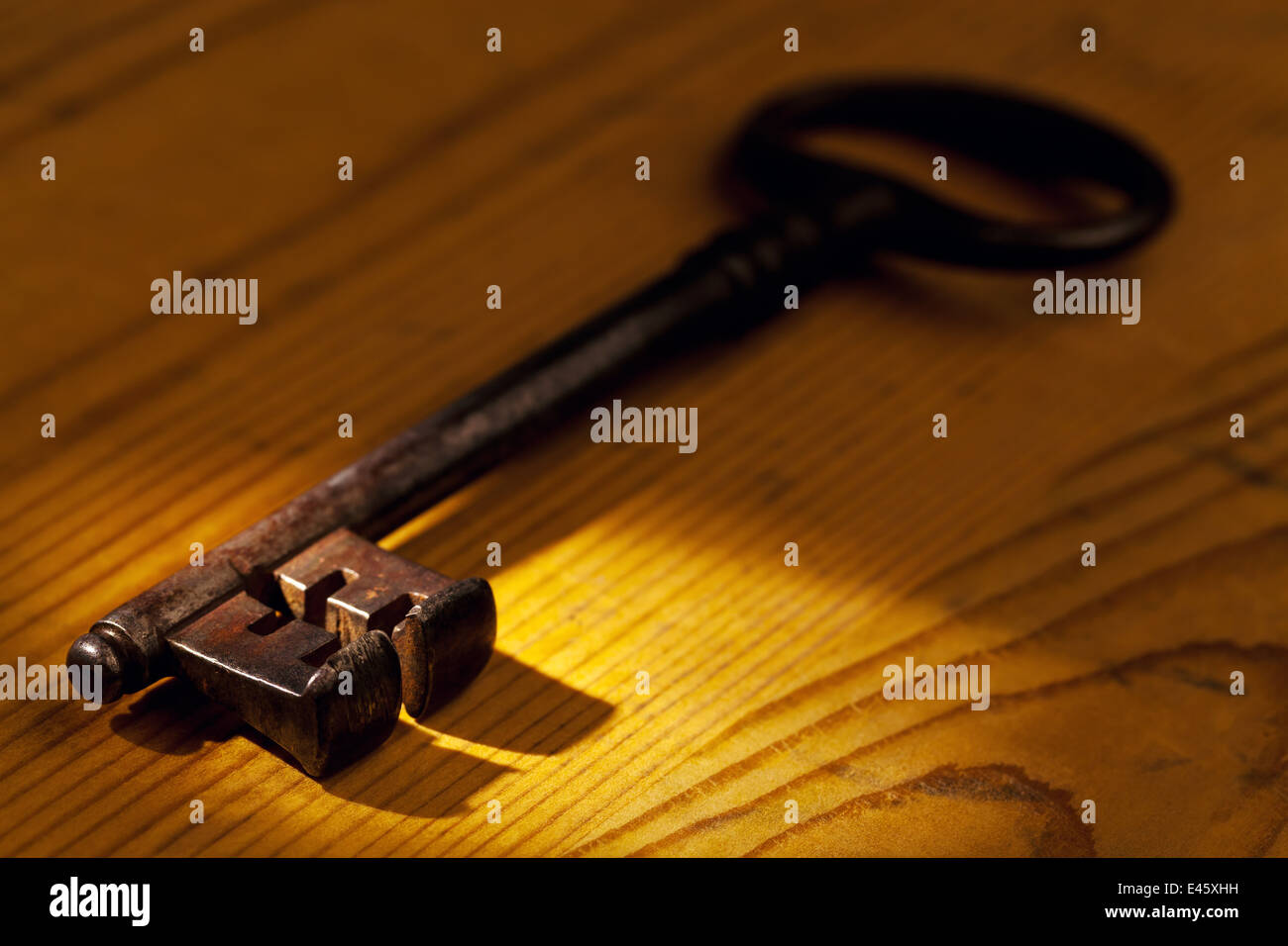 An old key lying on a white background Stock Photo - Alamy