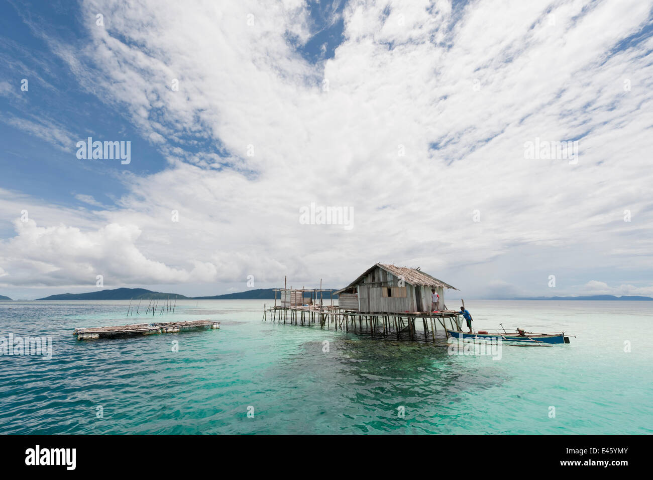 West Papuan house on stilts in coral reef shallows. Raja Ampat, West ...