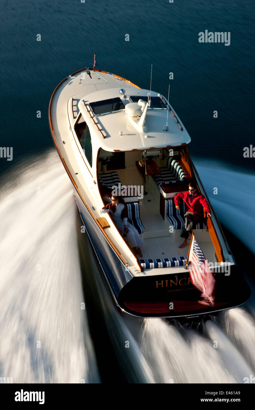 Couple on board Hinckley T38 speedboat planing off Rhode Island, USA ...