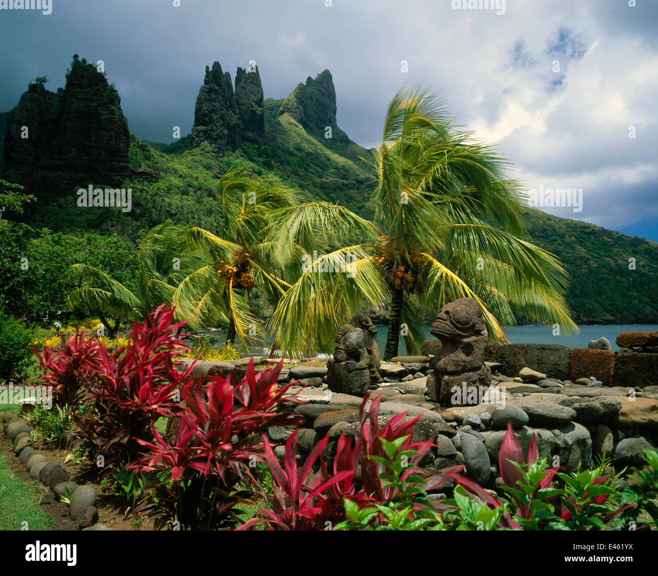 Lush vegetation and traditional statues in the Marquesas Islands ...