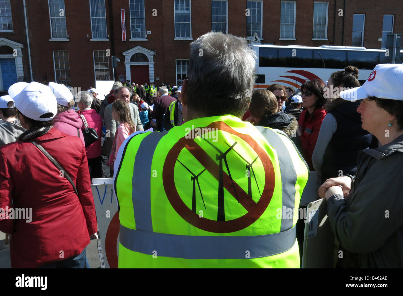 A man wears a hi-vis vest with an anti-turbine logo during a protest in ...