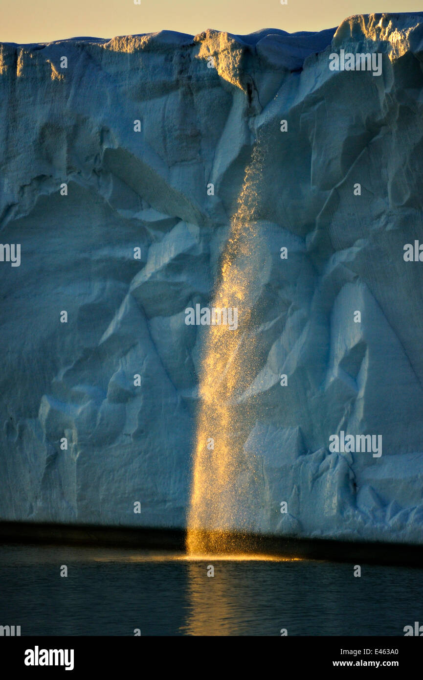 Ice cliff and waterfall catching evening light. Austfonna Polar Ice Cap ...