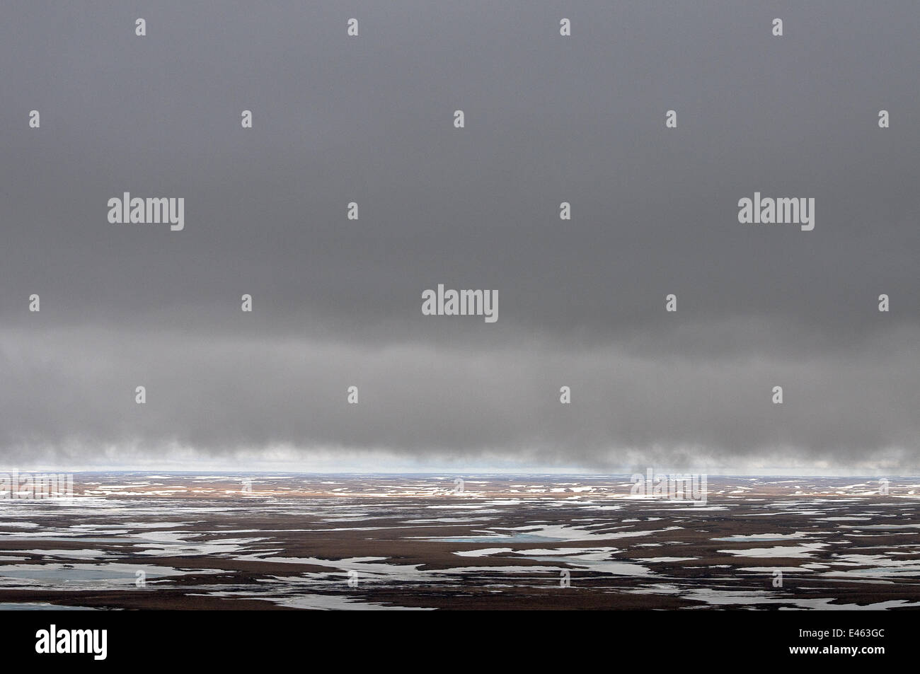 Storm clouds above partially frozen tundra, Taimyr Peninsula, Siberia ...