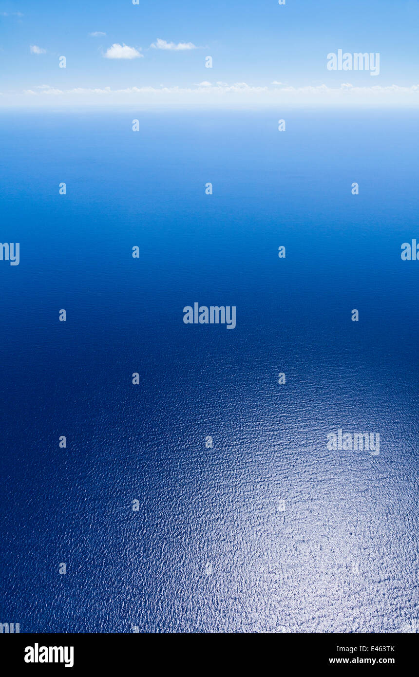 Aerial image showing light reflected off the deep blue of the sea ...