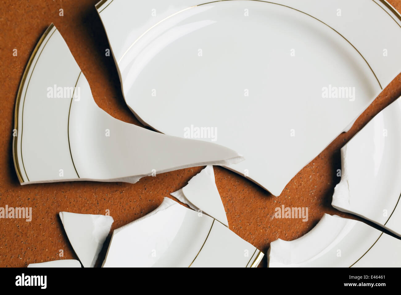 A broken plate lying on a red floor Stock Photo - Alamy