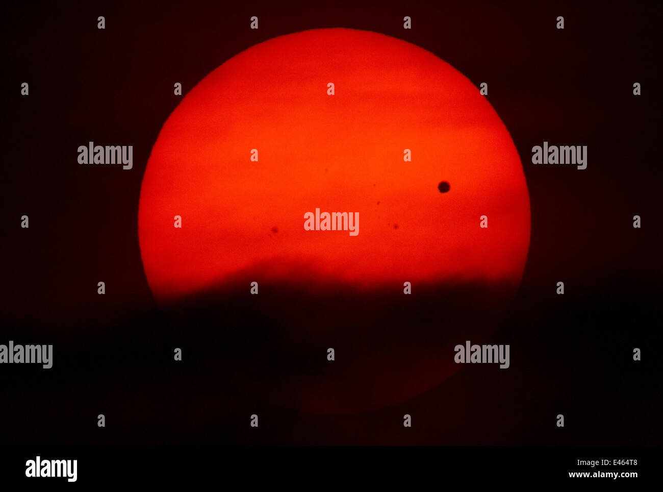 The transit of Venus across the face of the sun, with visible sunspots ...