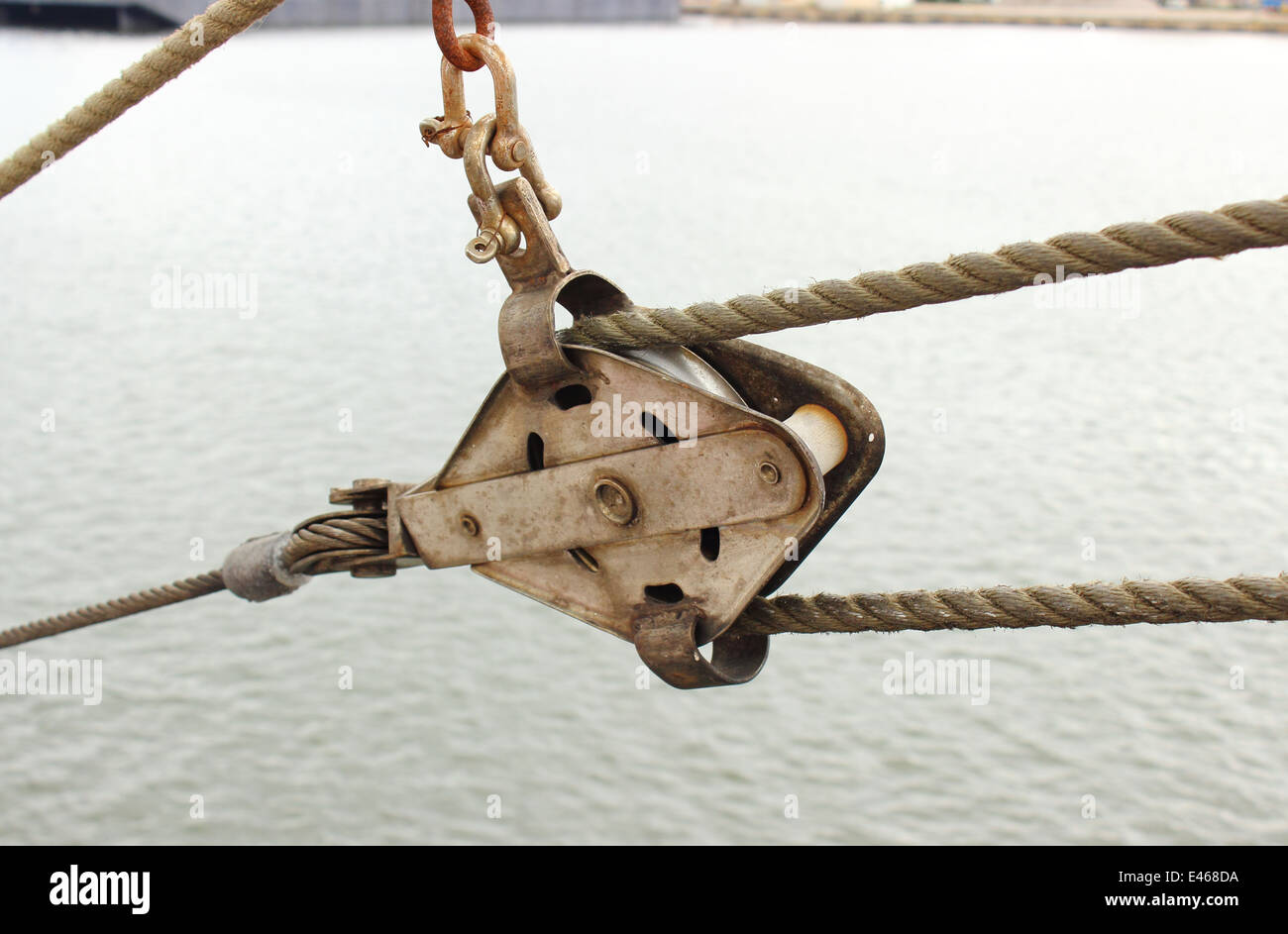 Closeup of old metal block and rigging at the yacht on sea background ...