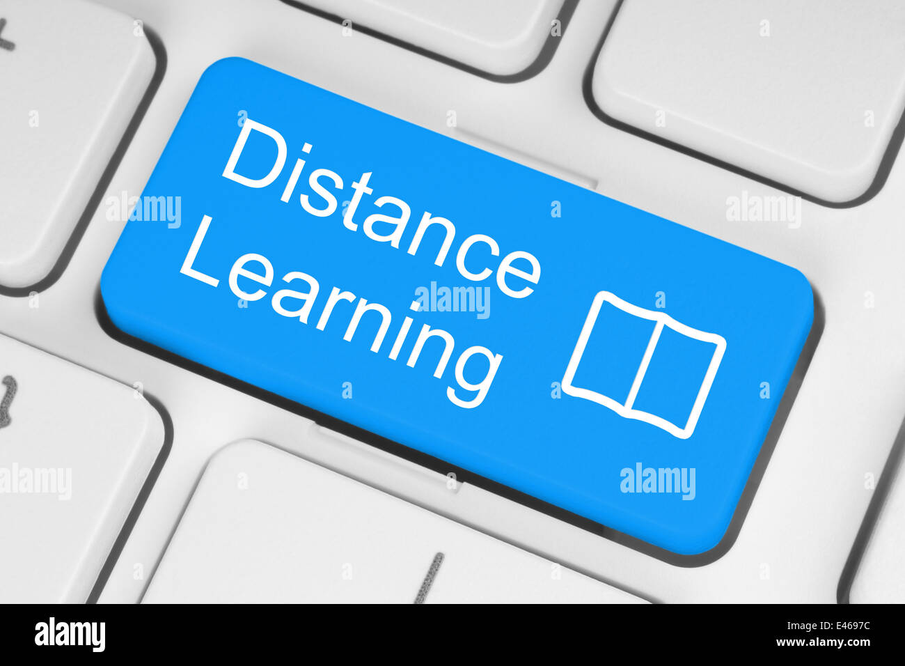 Blue distance learning button on white keyboard Stock Photo - Alamy