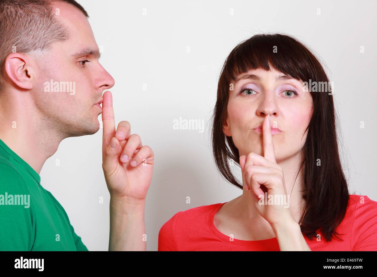 Woman and man showing hand silence sign, couple showing silence sign ...