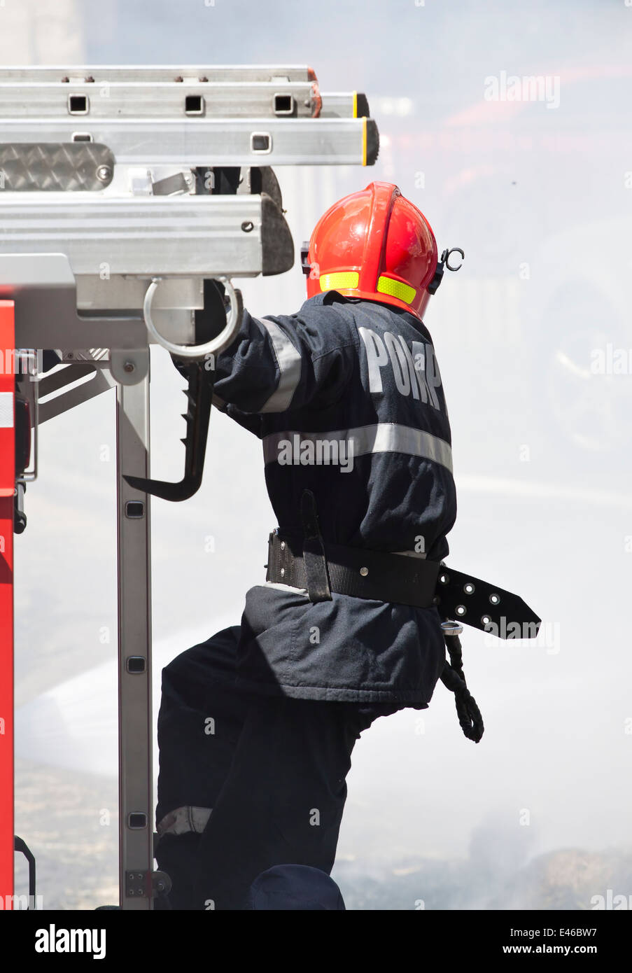 Firefighter in action - Fireman extinguishing a fire Stock Photo - Alamy