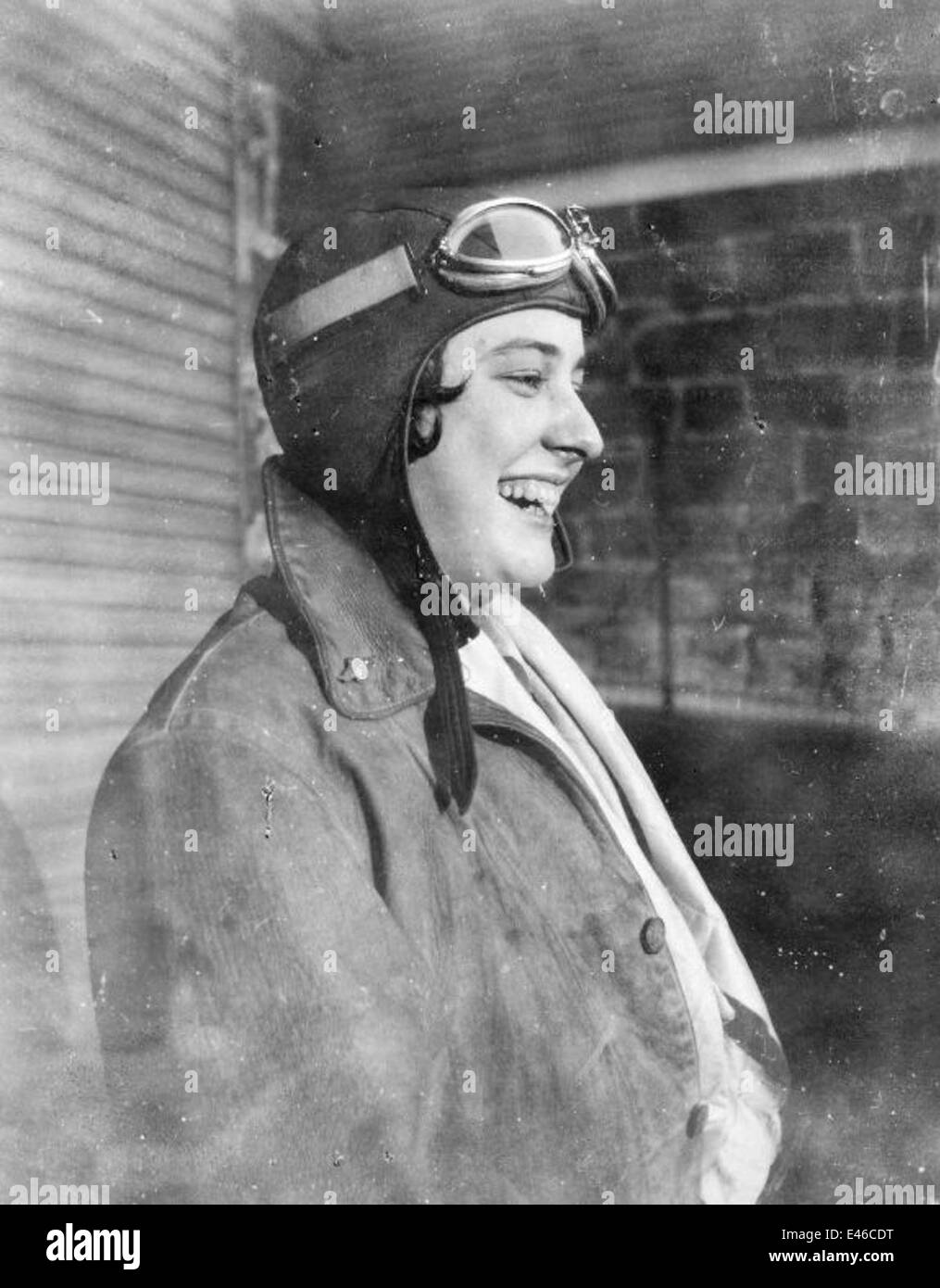 This image features a young female pilot, dressed in classic aviation ...