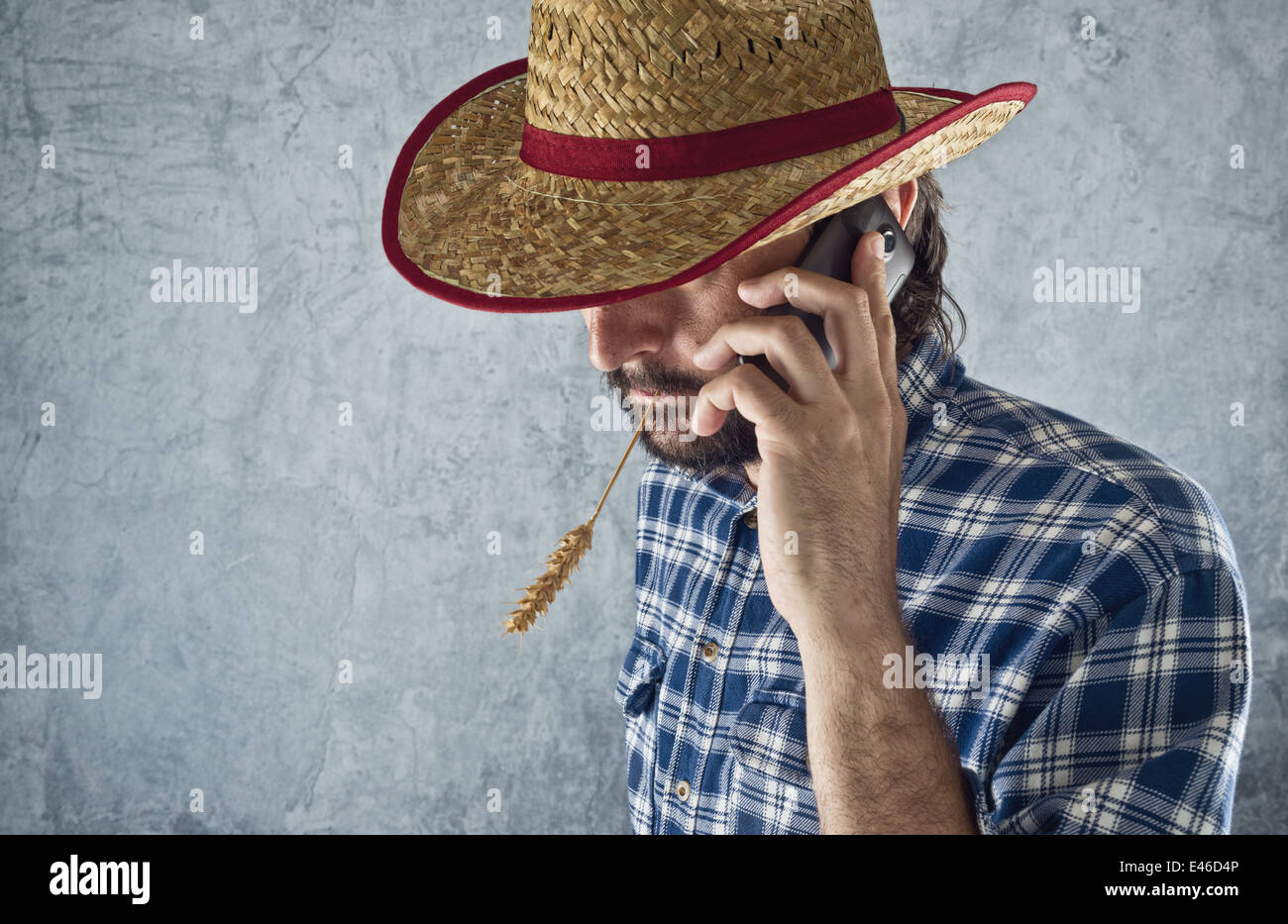 Farmer with cowboy straw hat talking on mobile phone Stock Photo - Alamy