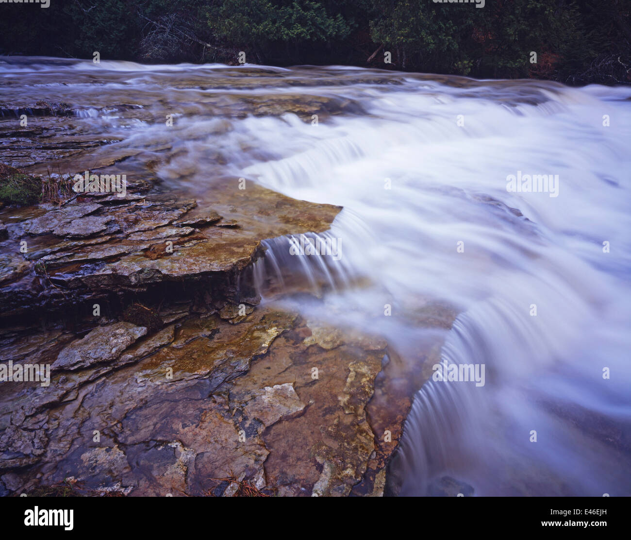Water tumbles over ledges in a snowmelt fed stream Stock Photo - Alamy