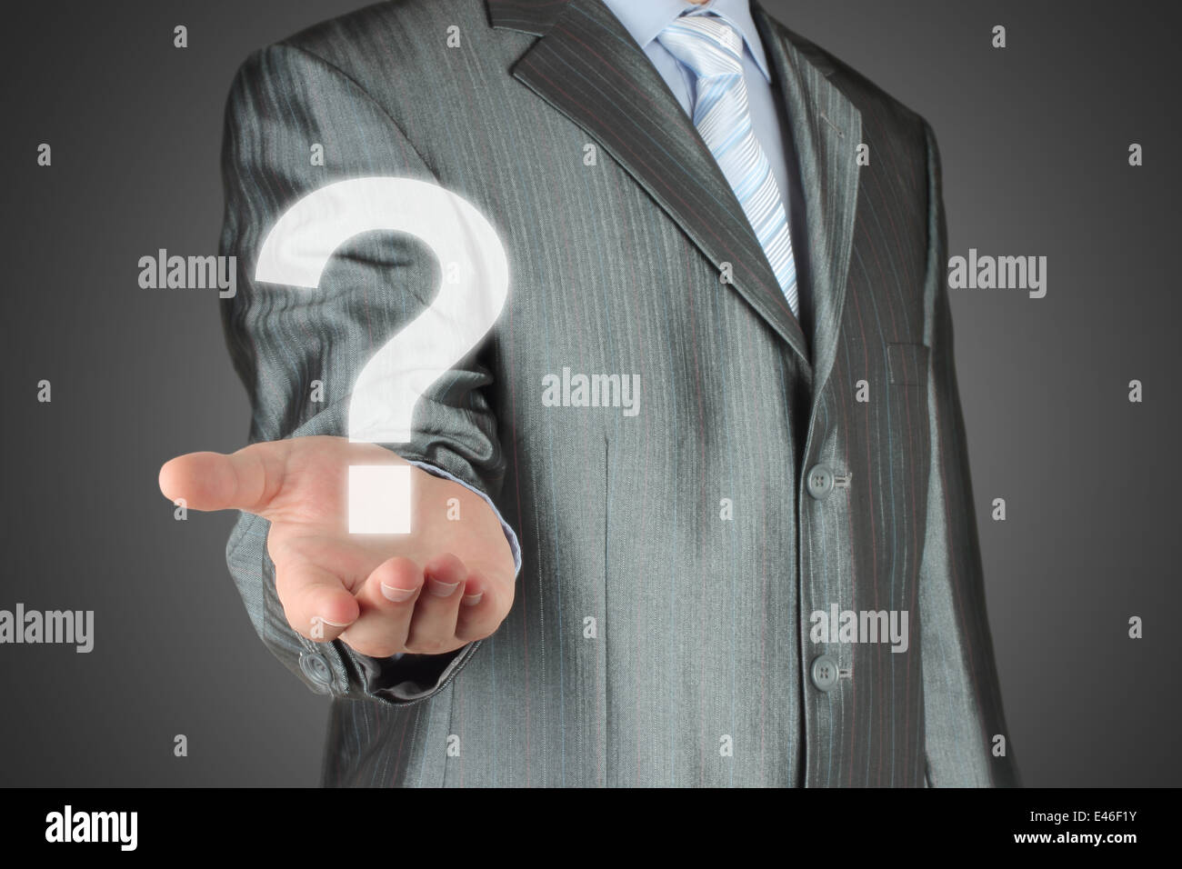 Businessman with question mark on dark background Stock Photo - Alamy
