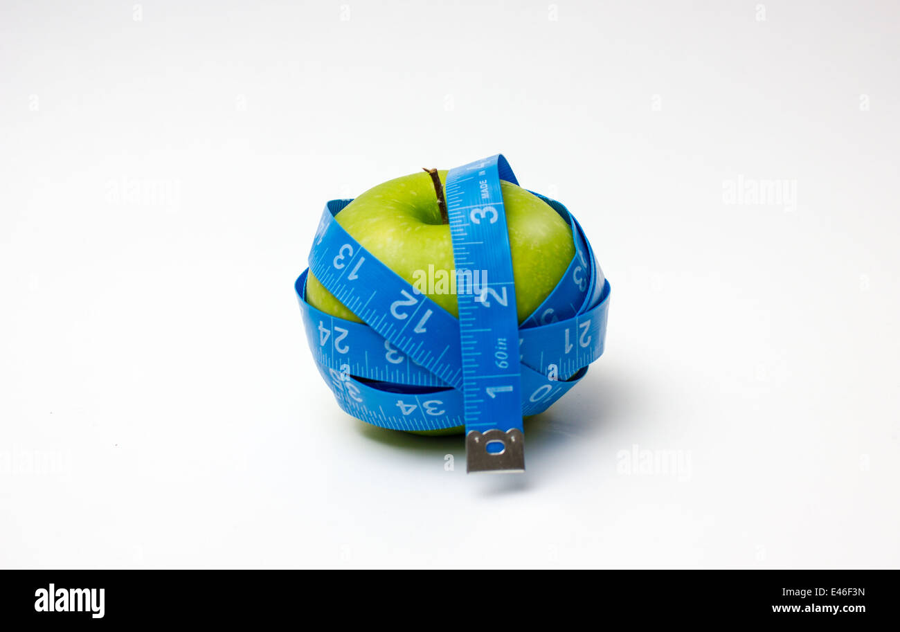 Apple wrap arround with measuring tape white background Stock Photo - Alamy