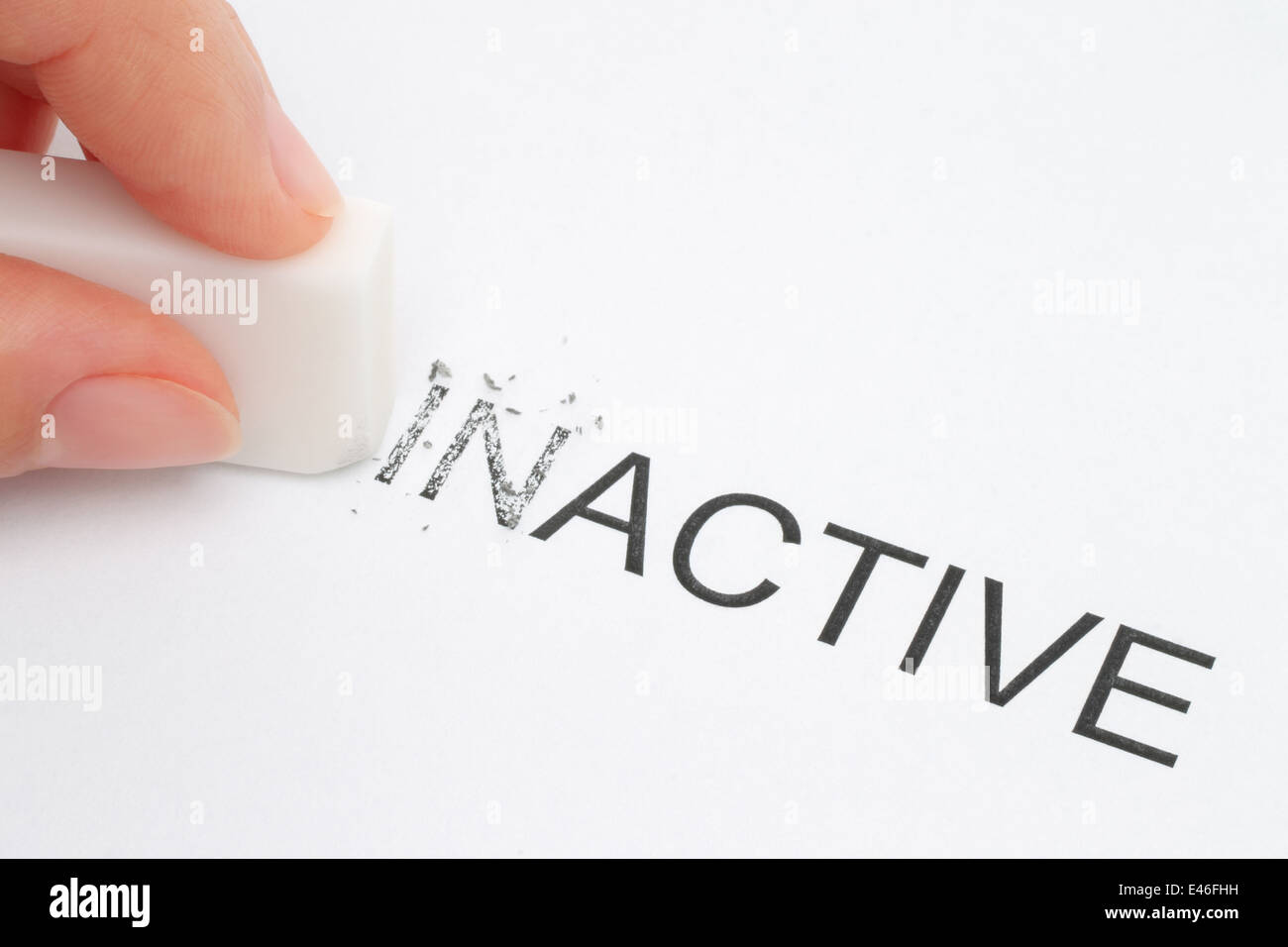 Hand erasing part of the inactive word close-up Stock Photo - Alamy
