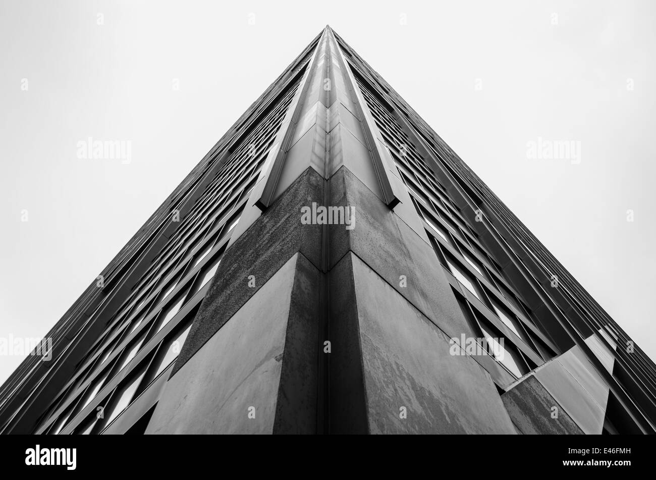Looking up the corner of a skyscraper building on an overcast day Stock ...