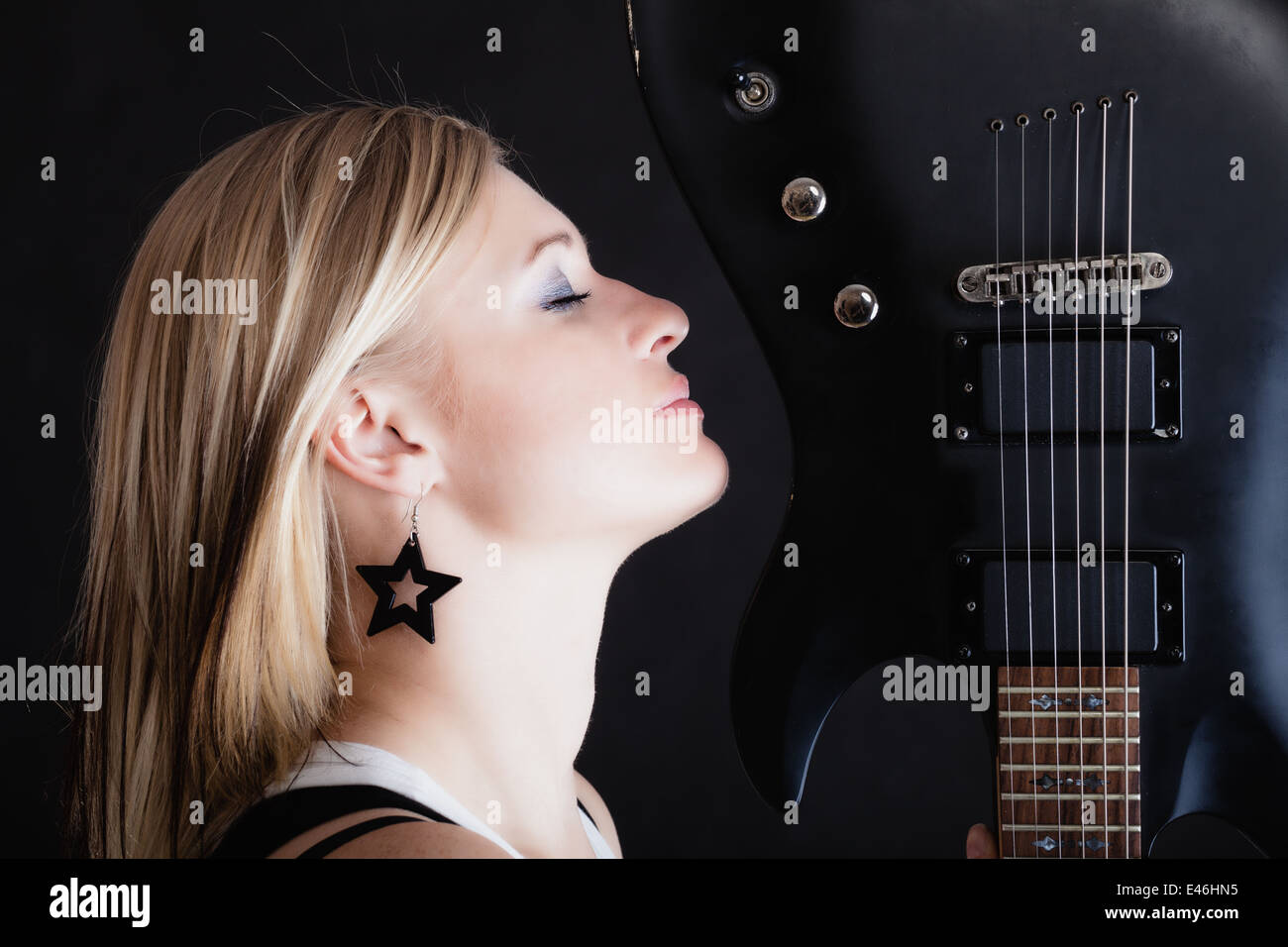 Rock music. Blonde girl guitarist musician performer with electric ...