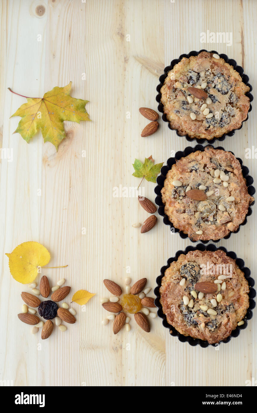Autumn still life of nut pastries and autumn leaves Stock Photo - Alamy
