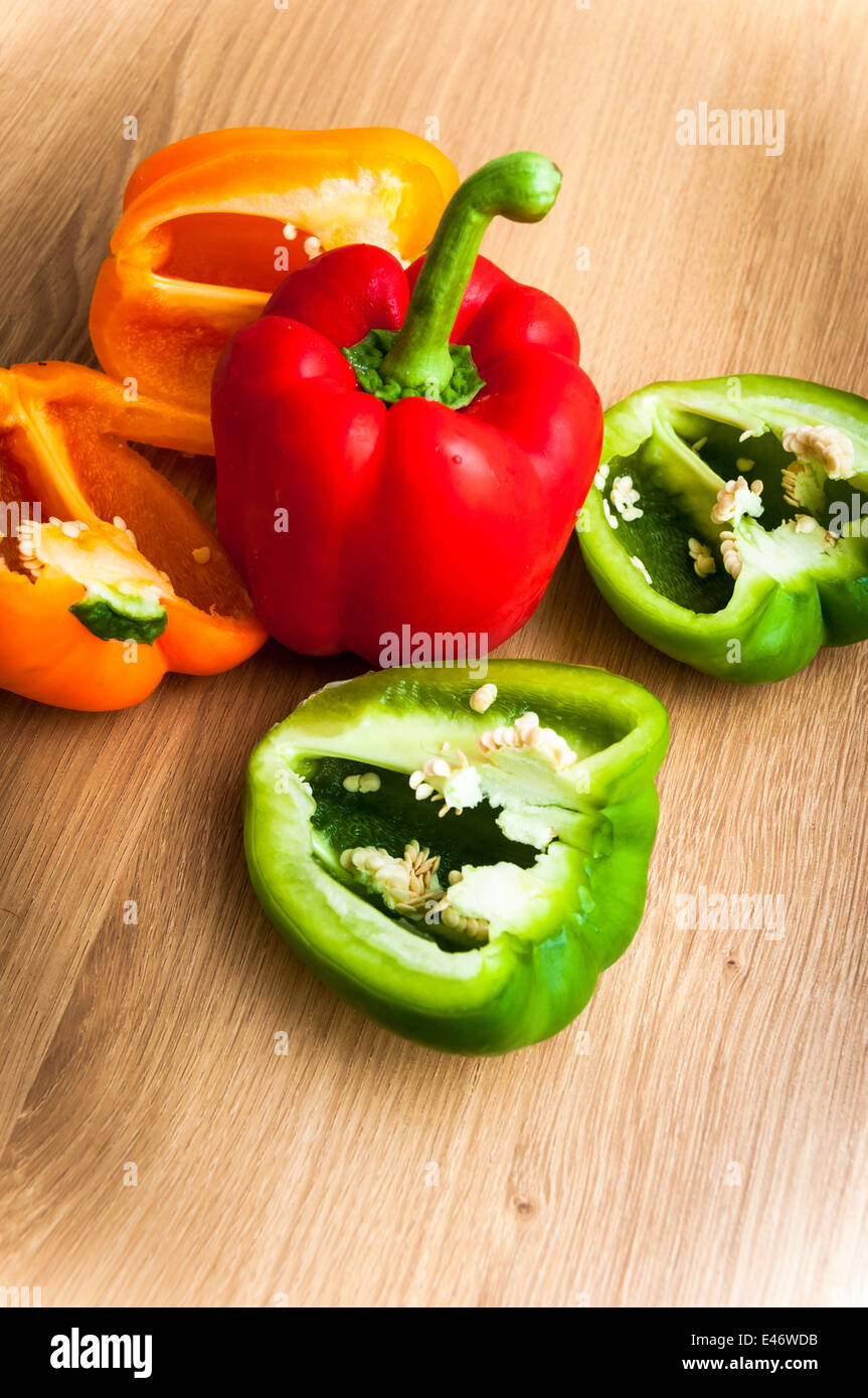 Set of colored bell peppers on wooden background Stock Photo - Alamy