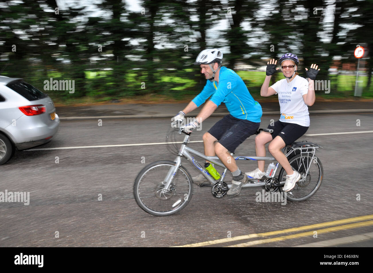 Couple riding a tandem bicycle taking part in a cycle sportive mass ...