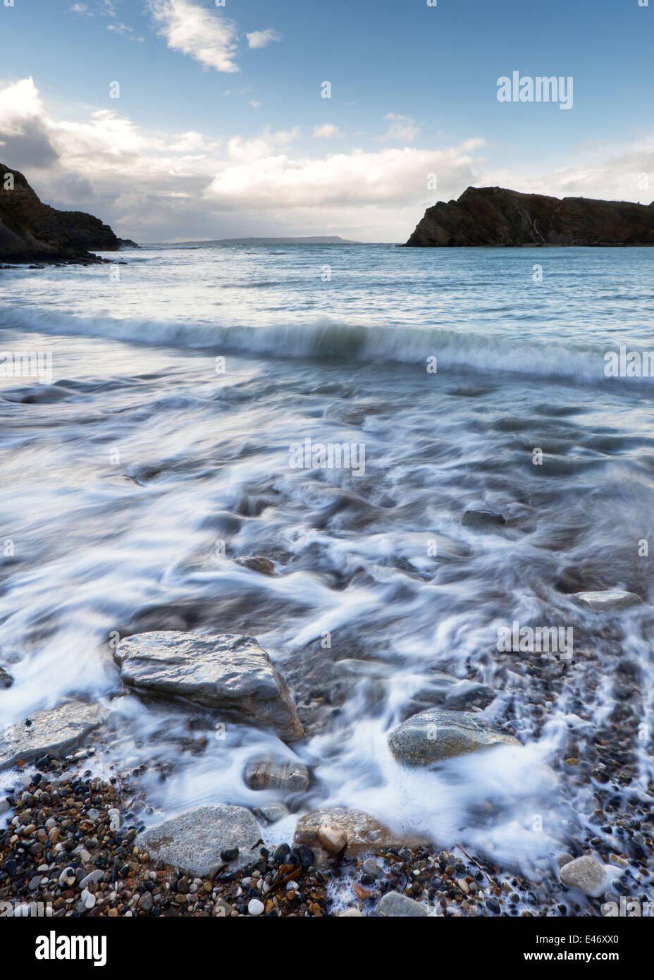 Receding waves on beach landscape long exposure Stock Photo - Alamy