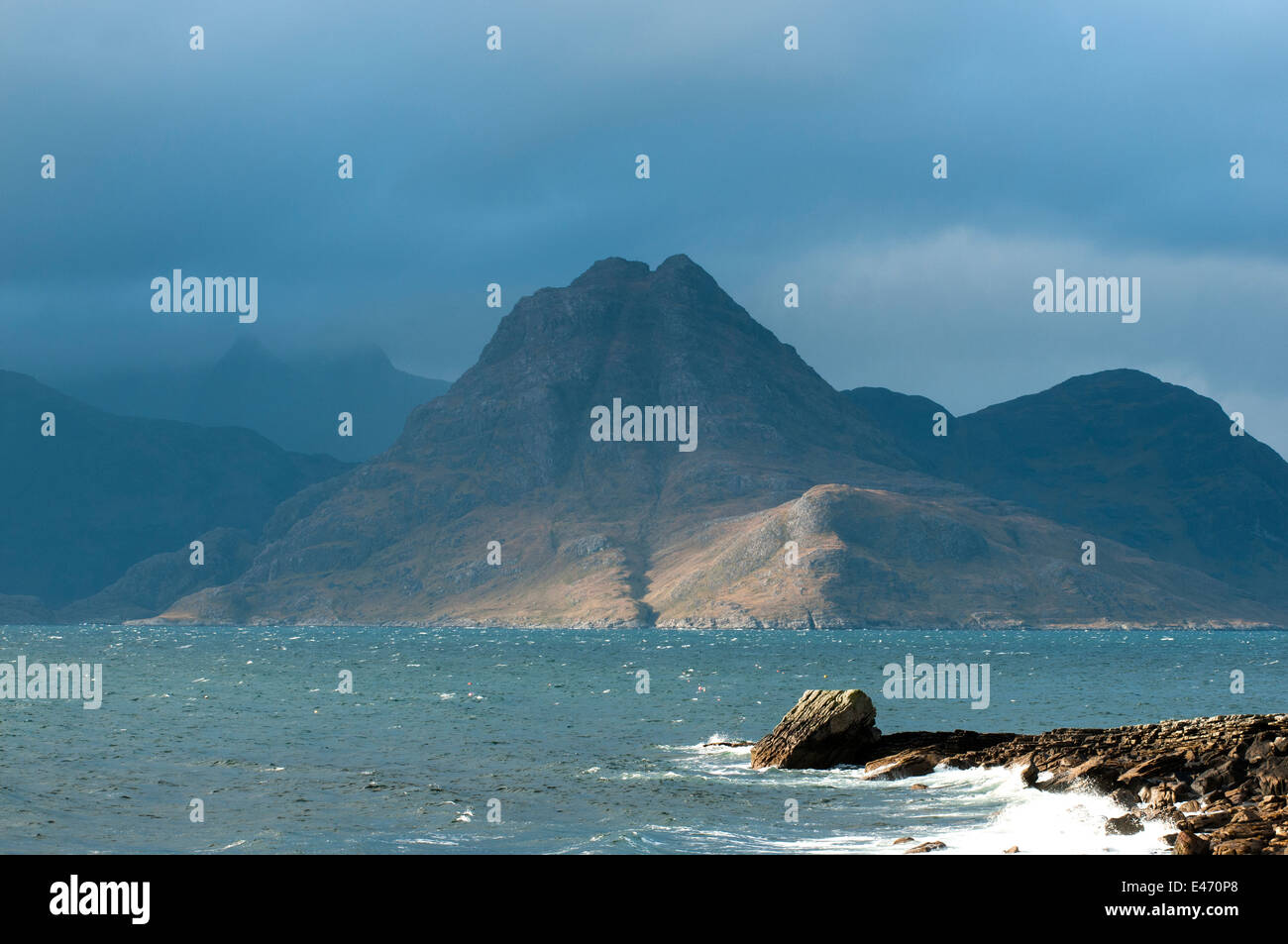 View across the sea to the Island of Soay from the rocky shore at Elgol ...