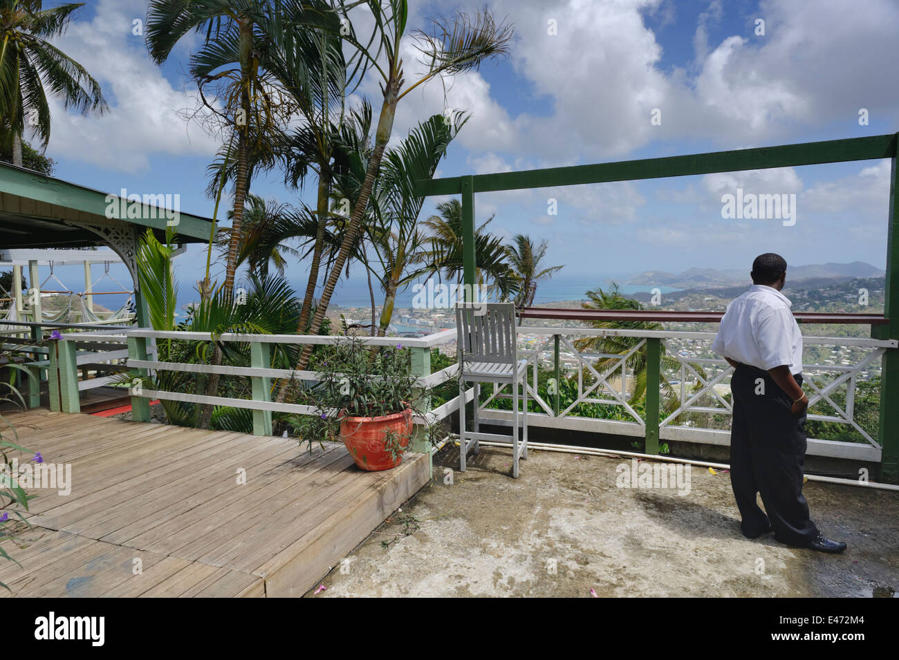 St Lucia: Tour guide waits for his fares outside a cafe while admiring ...