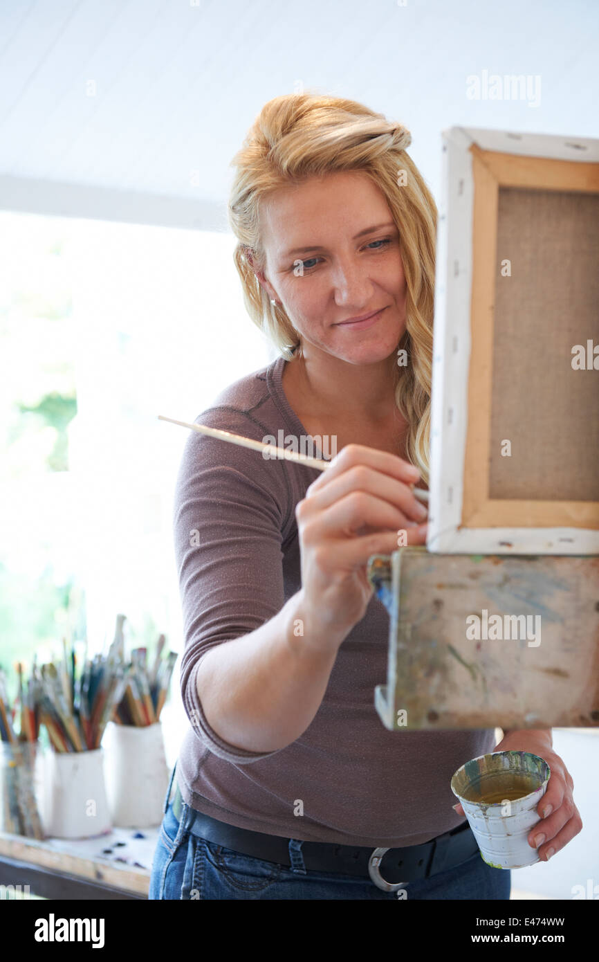 Female Artist Painting In Studio Stock Photo - Alamy
