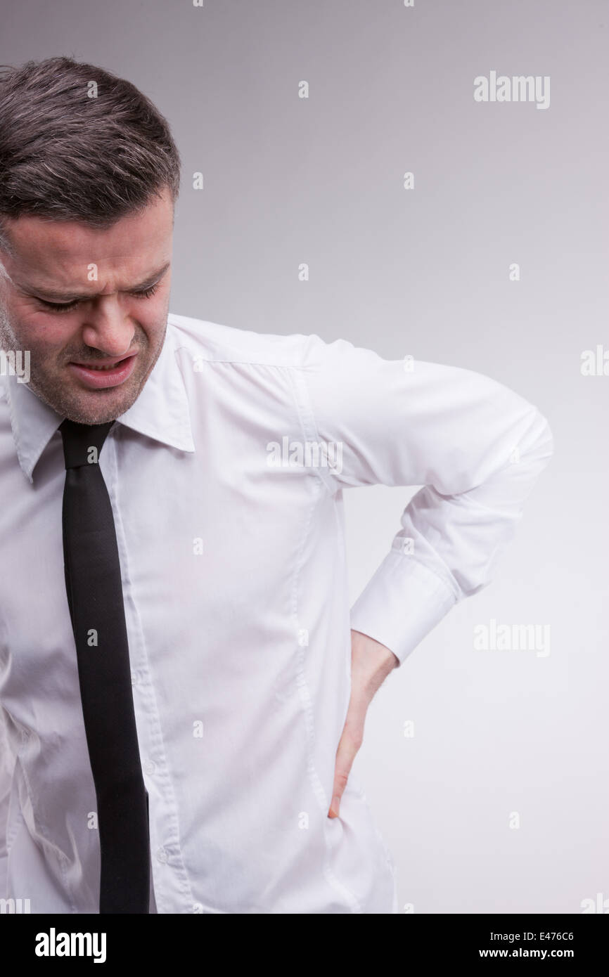 a man massaging his back because of his severe pain on his back Stock ...