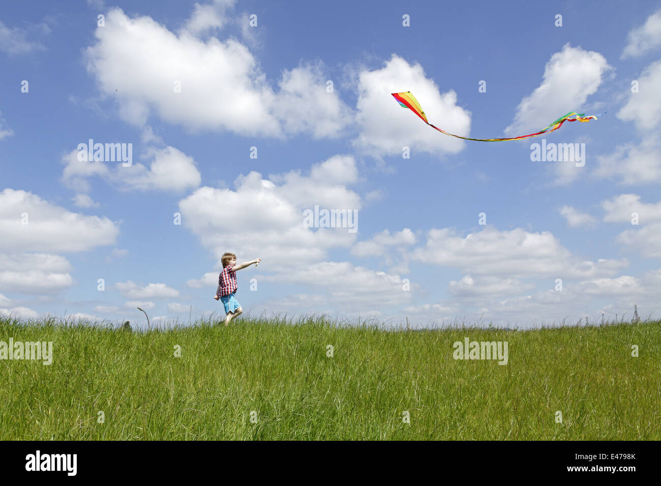 young boy flying a kite Stock Photo - Alamy