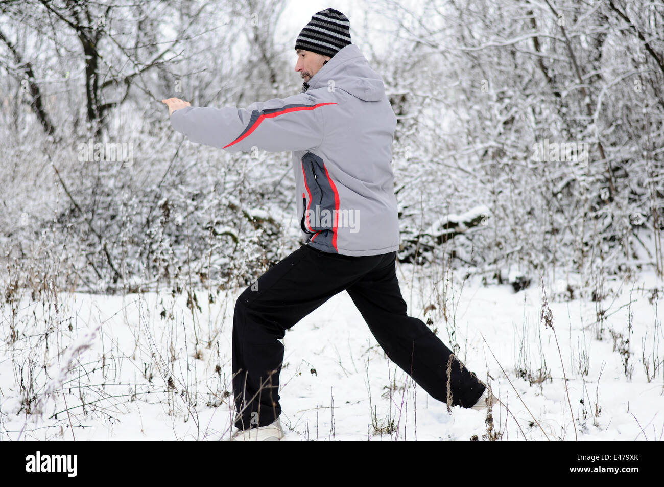 man medium years sports exercise gym workout open air winter park snow ...