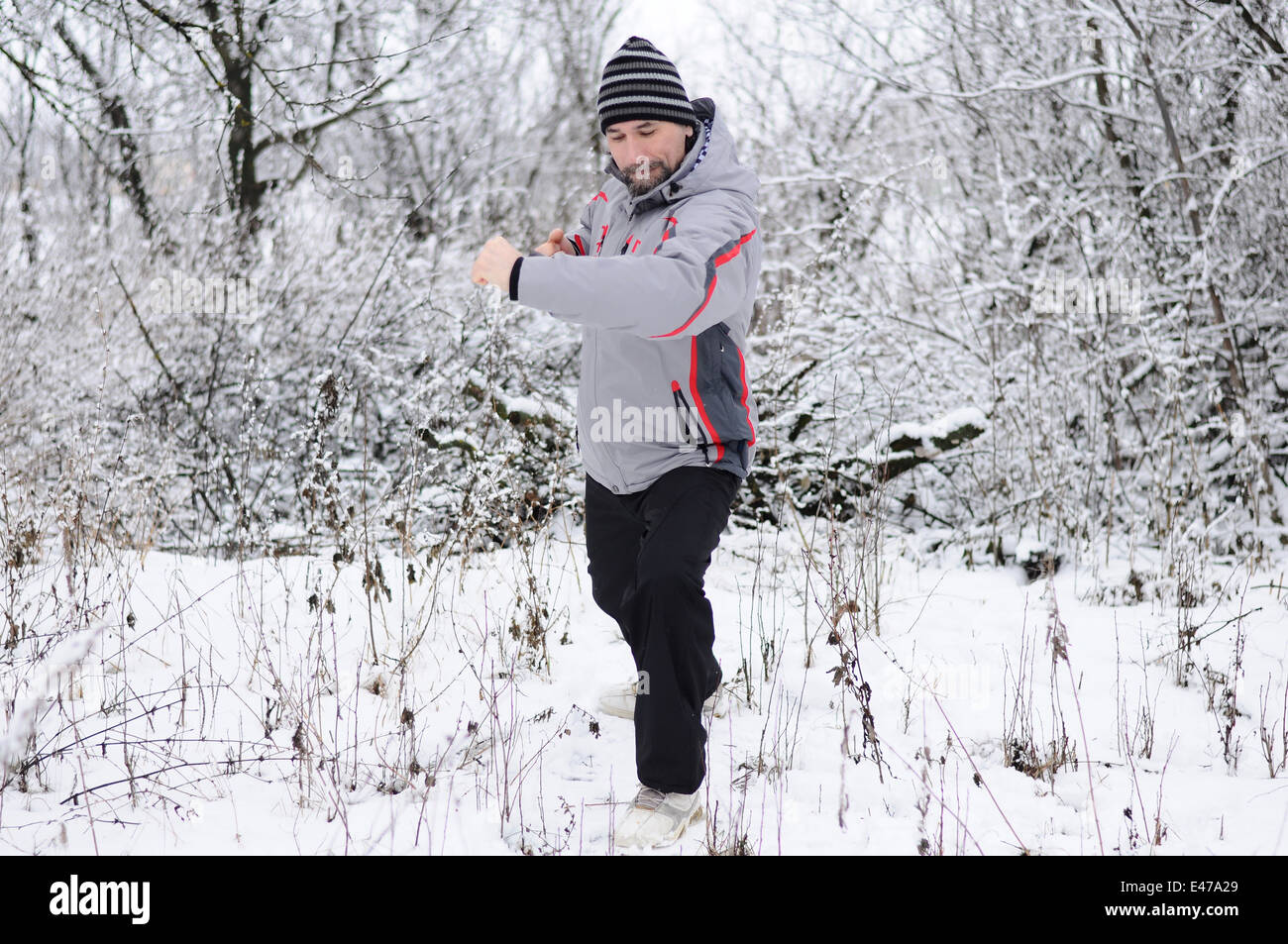 man medium years sports exercise gym workout open air winter park snow ...