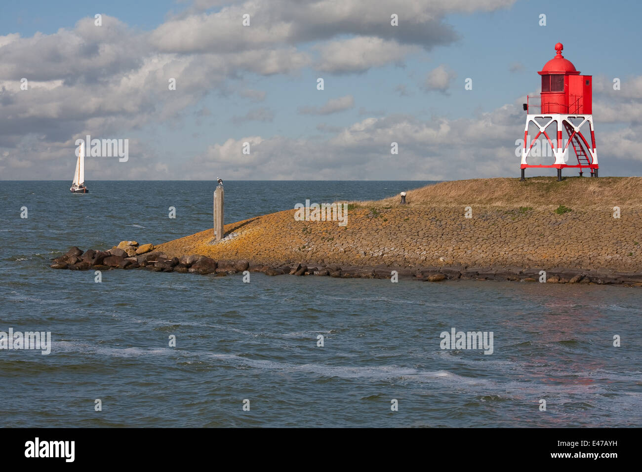 Sailing ship leaving a dutch harbor, with the red beacon behind Stock ...