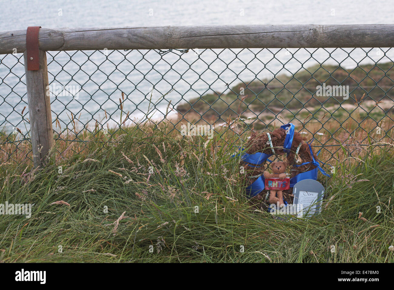 memorial wreath to Rhys on clifftop left by fence overlooking the sea ...