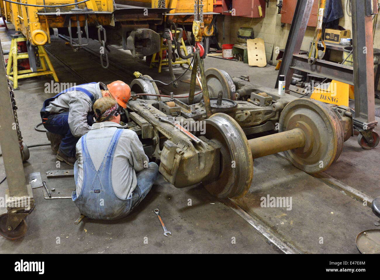 Engineers fixing a railway axle in an engineering shop Stock Photo - Alamy