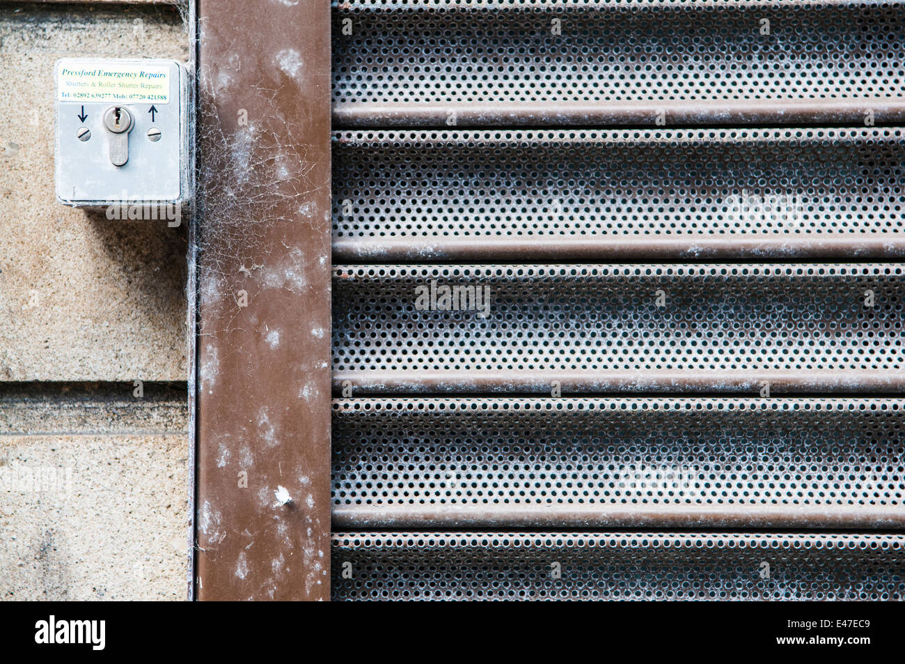 Keyhole switch to operate a shop shutter Stock Photo - Alamy