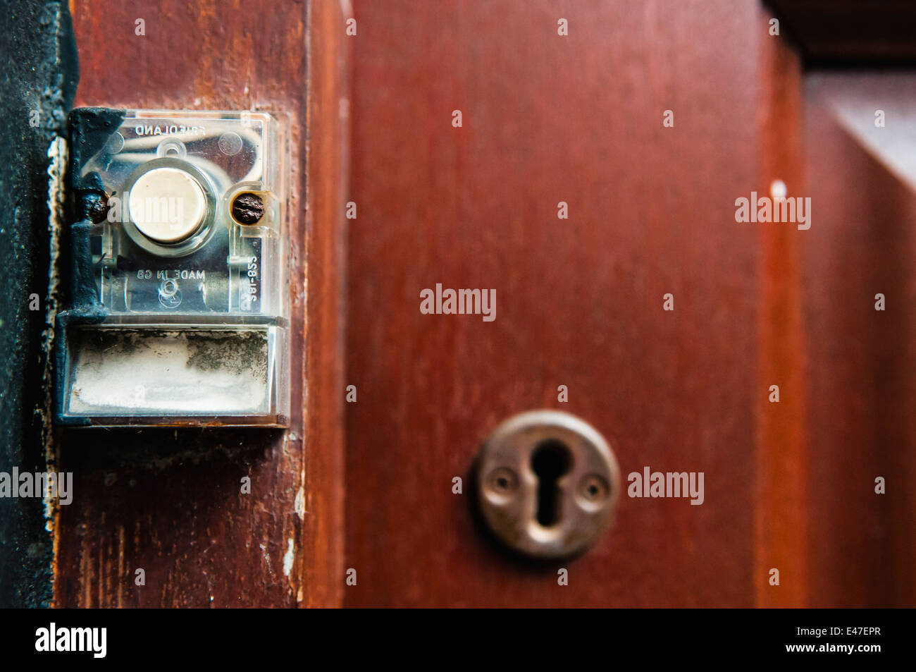 Push button door bell on a door frame Stock Photo - Alamy