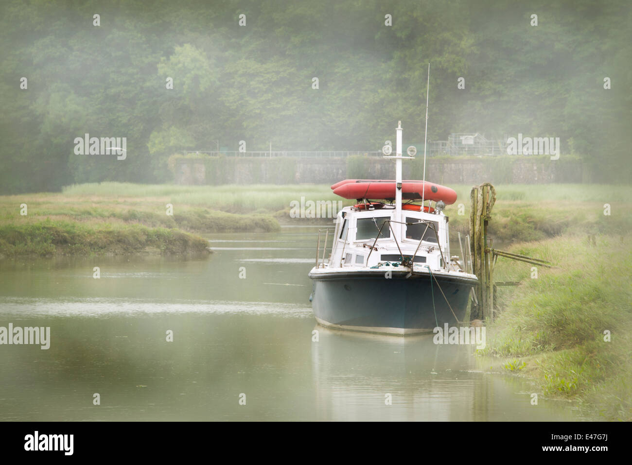 A small fishing boat docked in a canal Stock Photo - Alamy