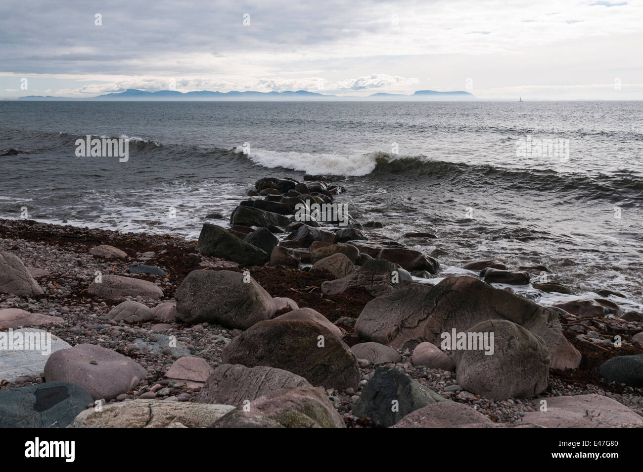 Looking at the Isle of Skye from Melvaig shore on a cloudy day across ...