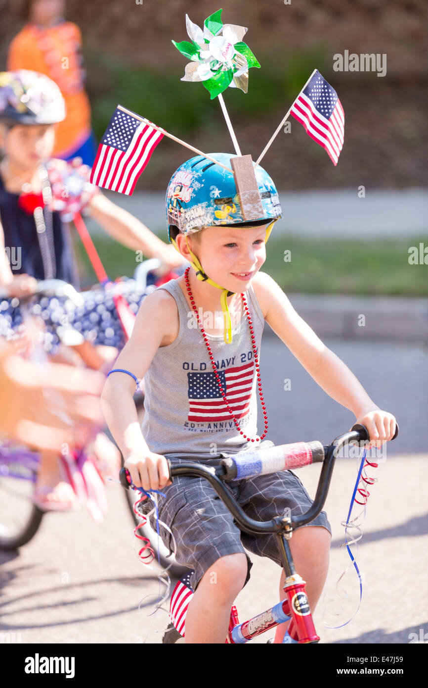 Young children dressed in patriotic costumes ride bicycles during the I ...