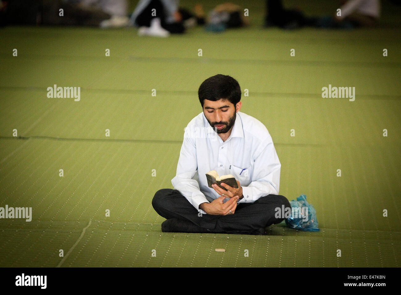 Tehran, Iran. 4th July, 2014. An Iranian Muslim reads Koran during ...