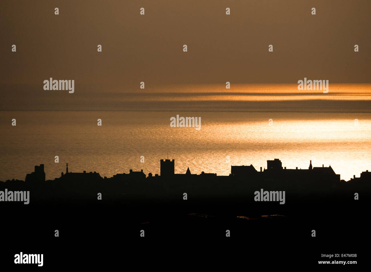Aberystwyth townscape skyline in silhouette against the golden glow of ...