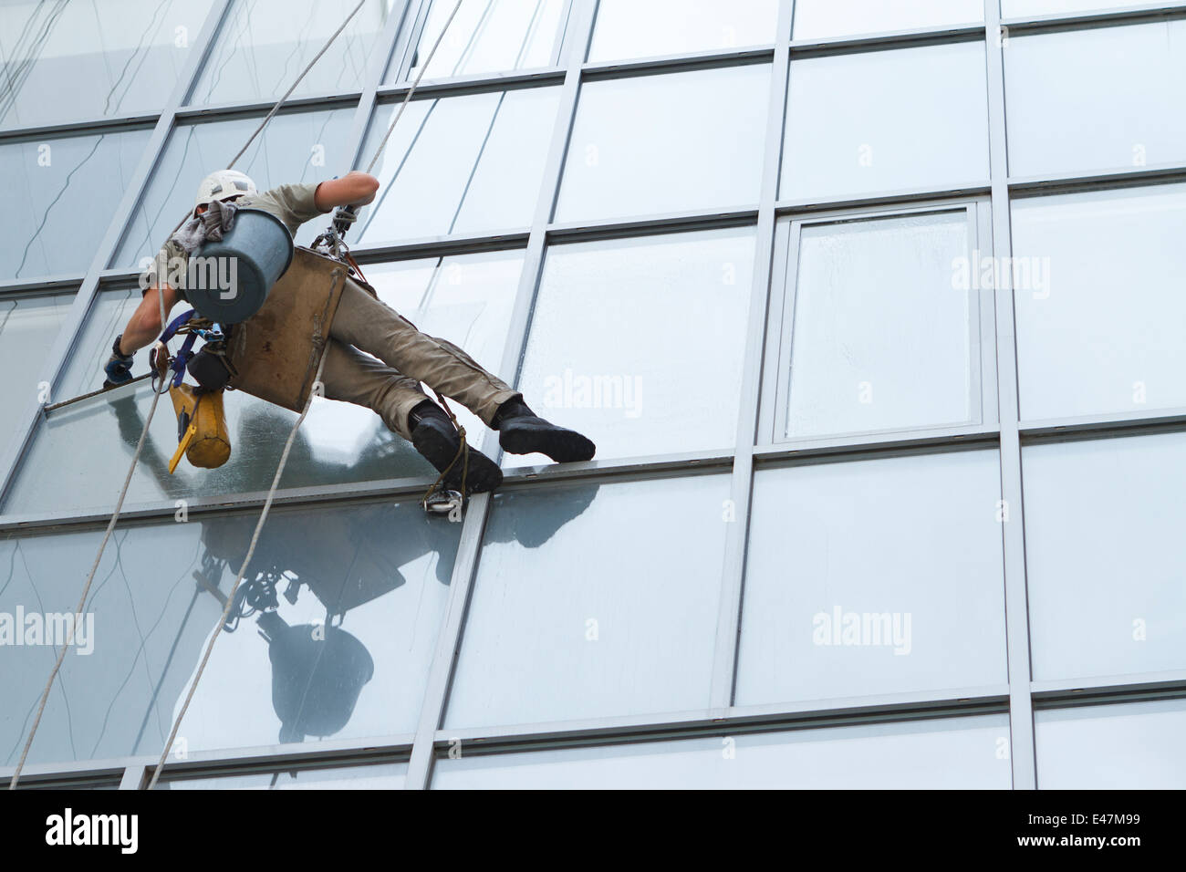 Window cleaner at work on glass wall Stock Photo - Alamy
