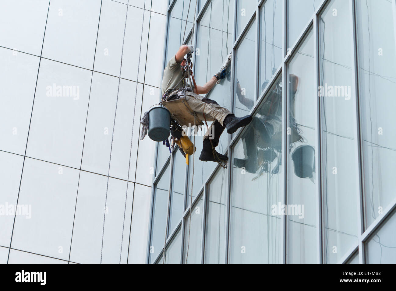Window cleaner at work on glass wall Stock Photo - Alamy
