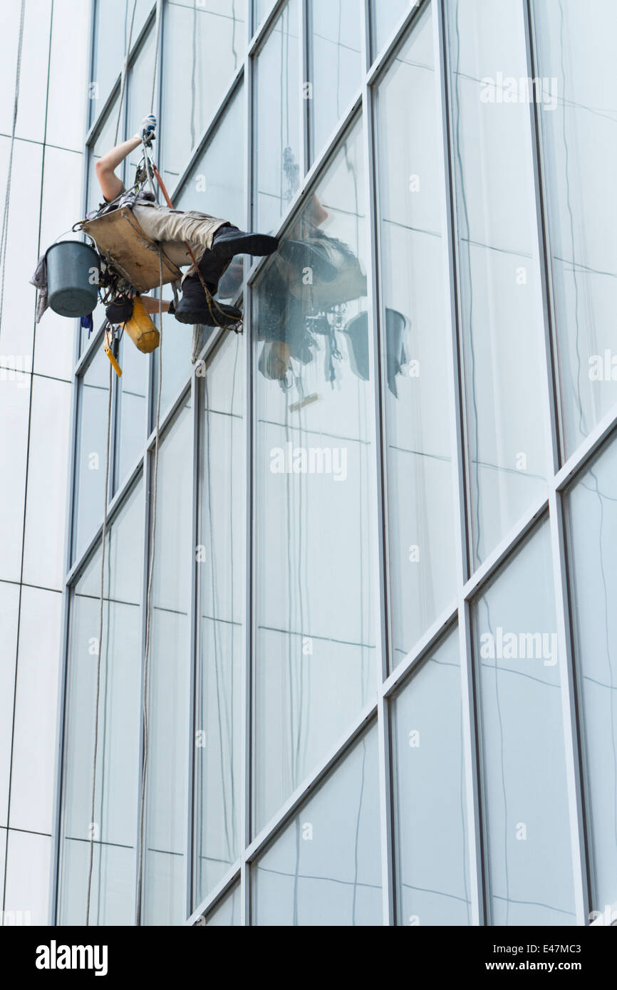 Window cleaner at work on glass wall Stock Photo - Alamy