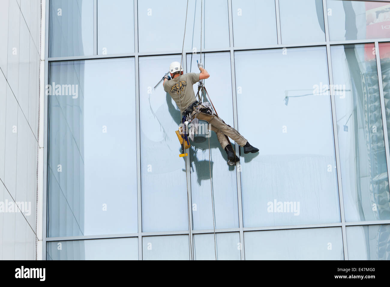 Window cleaner at work on glass wall Stock Photo - Alamy