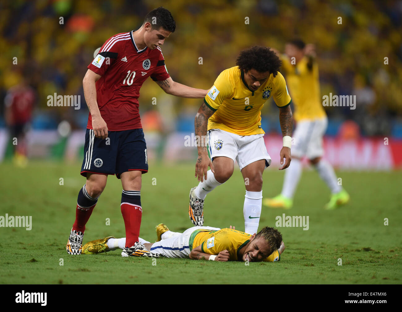 Fortaleza, Brazil. 04th July, 2014. Neymar (C) of Brazil lies on the pitch after picking up an ...
