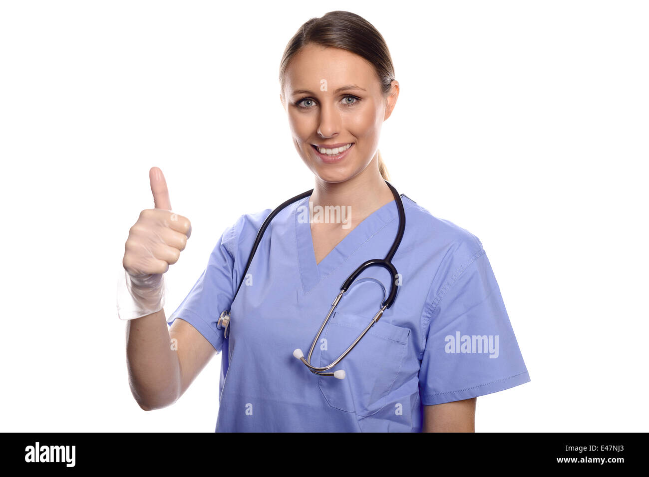 Young female nurse or doctor in blue scrubs holding up her thumbs to ...