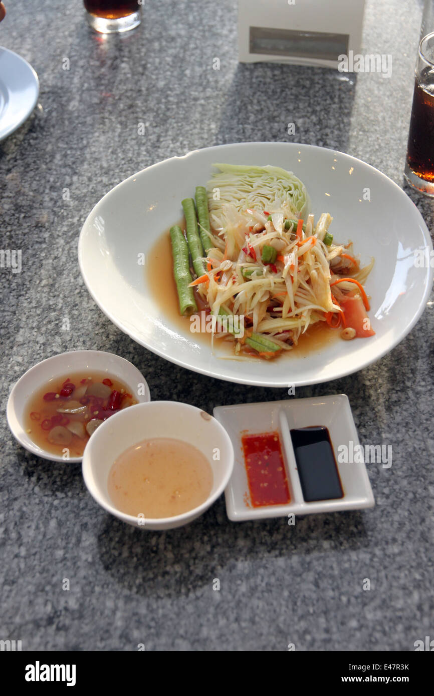 green papaya salad in white dish on the foods table Stock Photo - Alamy